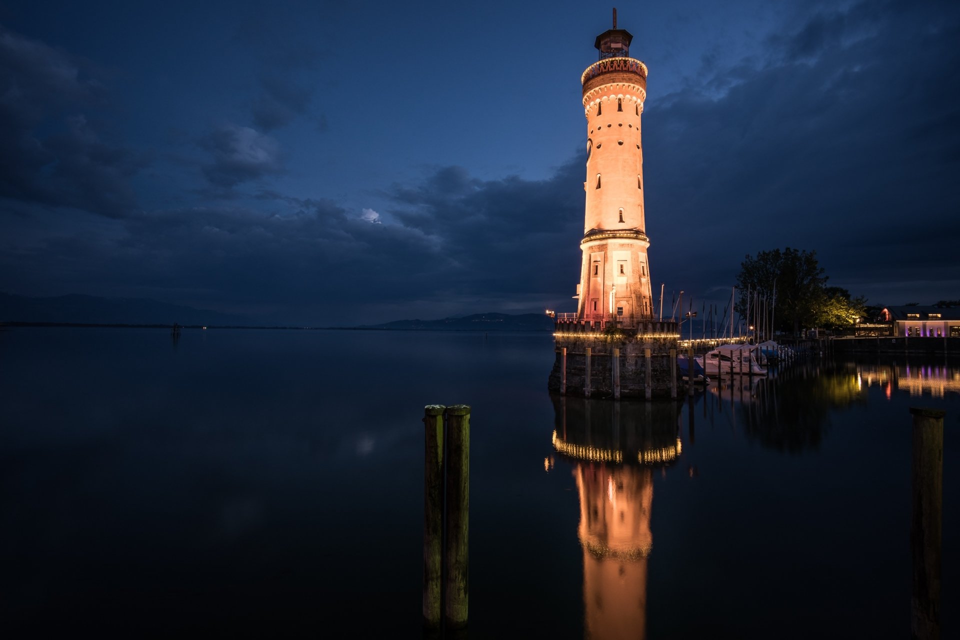 Luminous Lighthouse Reflection: Nighttime HD Wallpaper of Man-Made Beacon