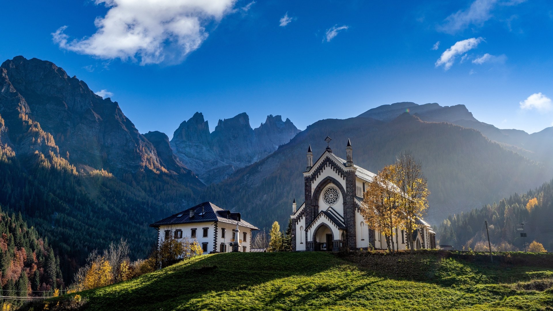 Alpine Serenity: 4K Ultra HD Church and Home Amid Majestic Mountain Peaks