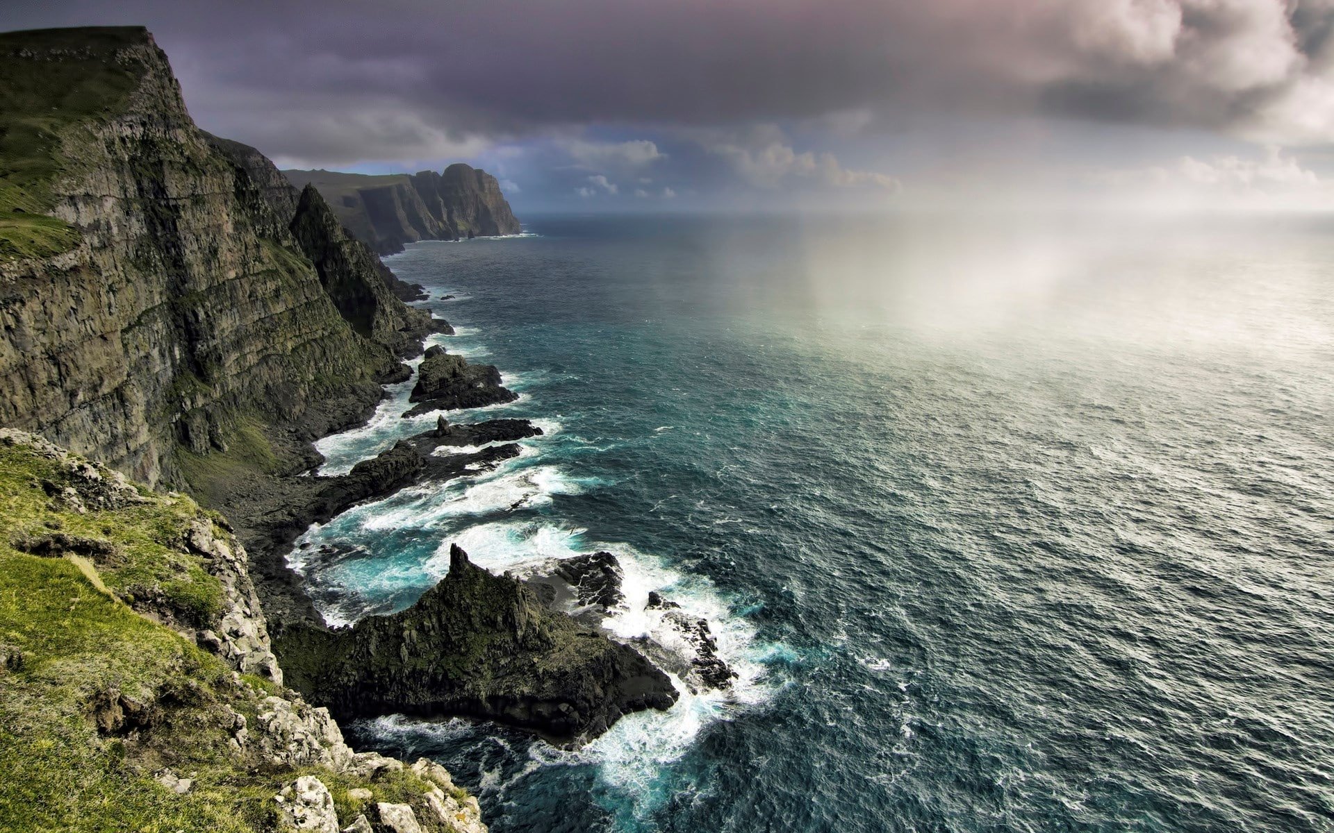 Coastal Majesty: Clouds Over Rugged Cliffs | 1920x1200 | Wallpaper Abyss
