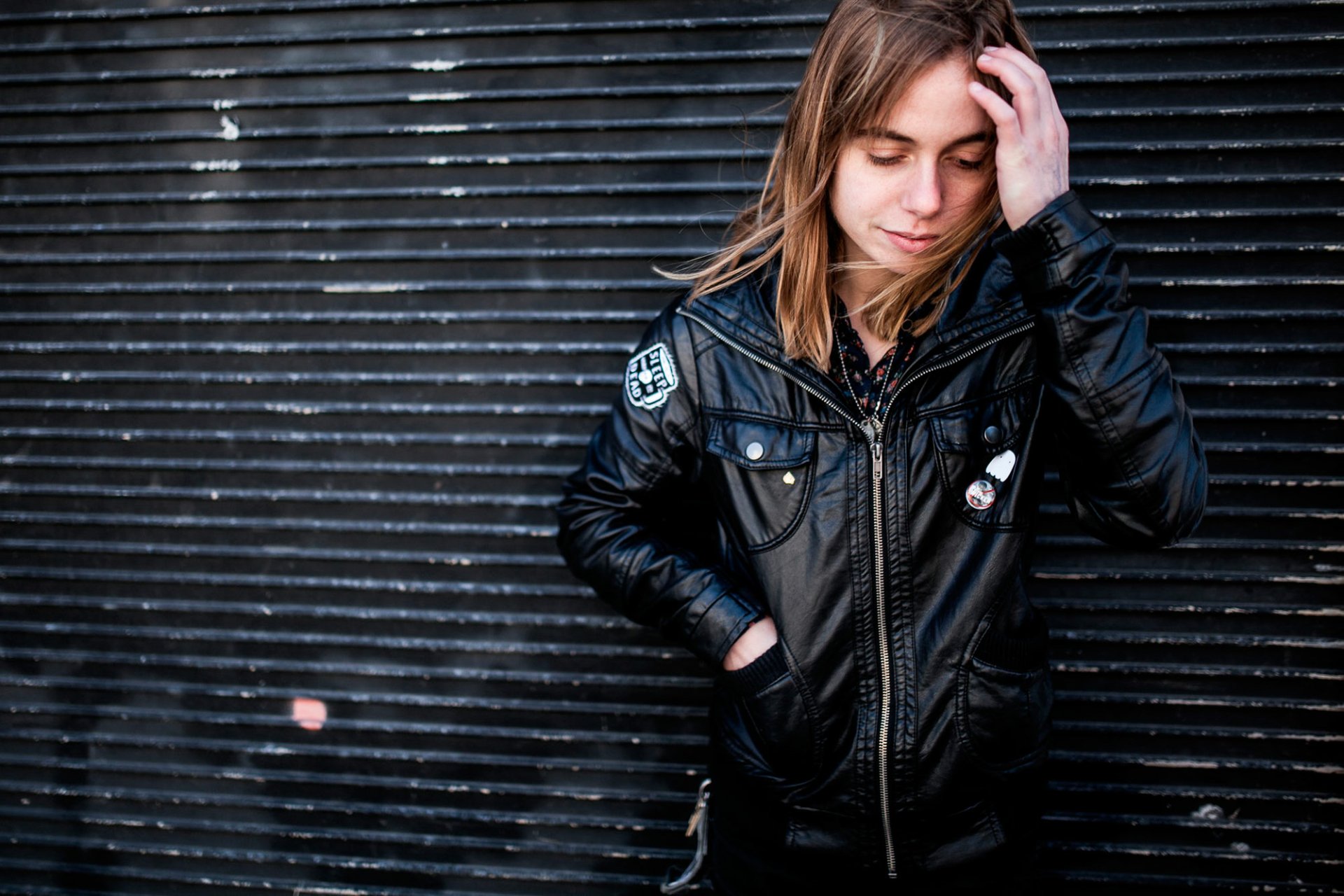 Contemplative Music Artist in Leather Jacket — HD Wallpaper