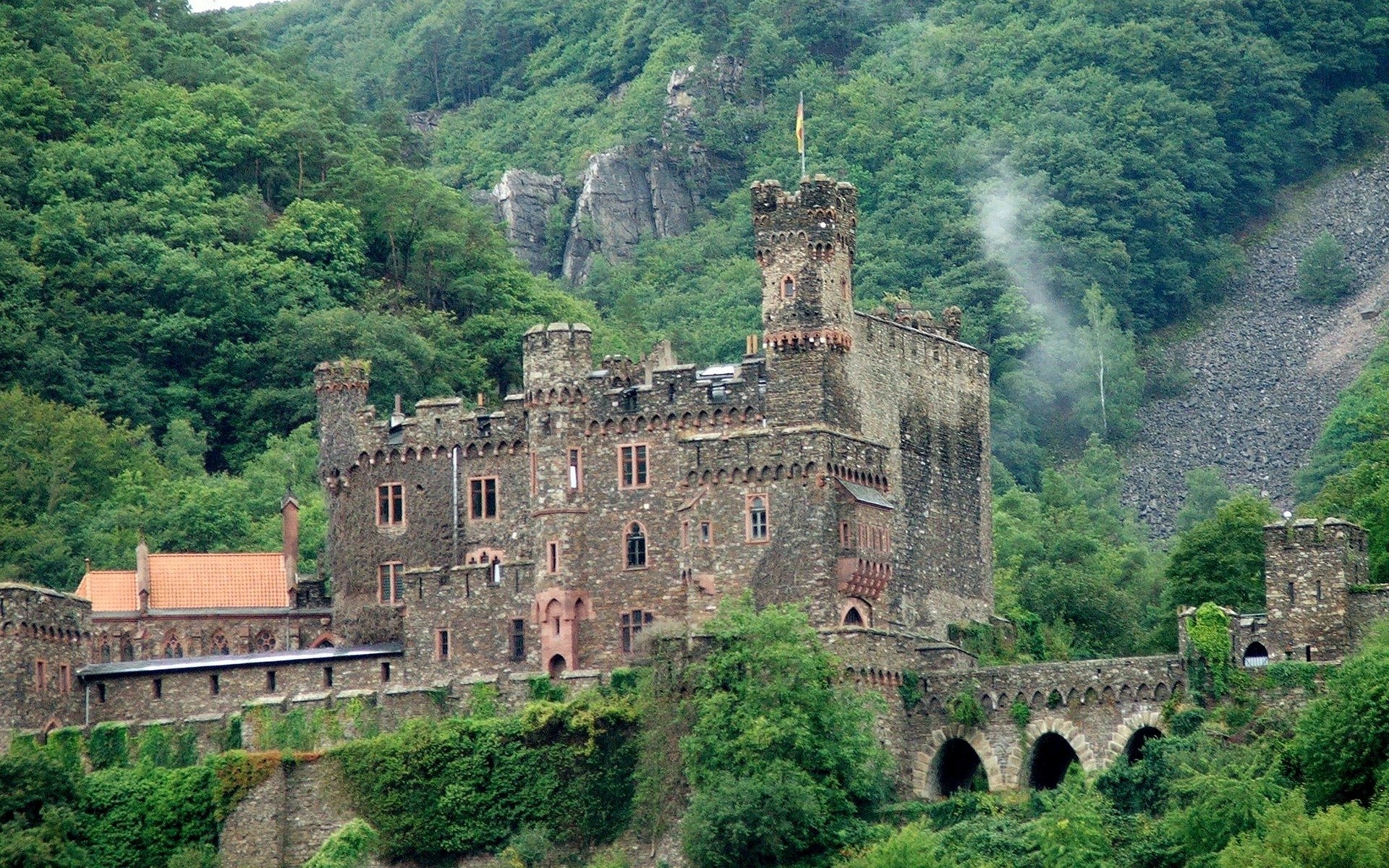 Majestic Fortress in Lush Mountains – HD Castle Wallpaper