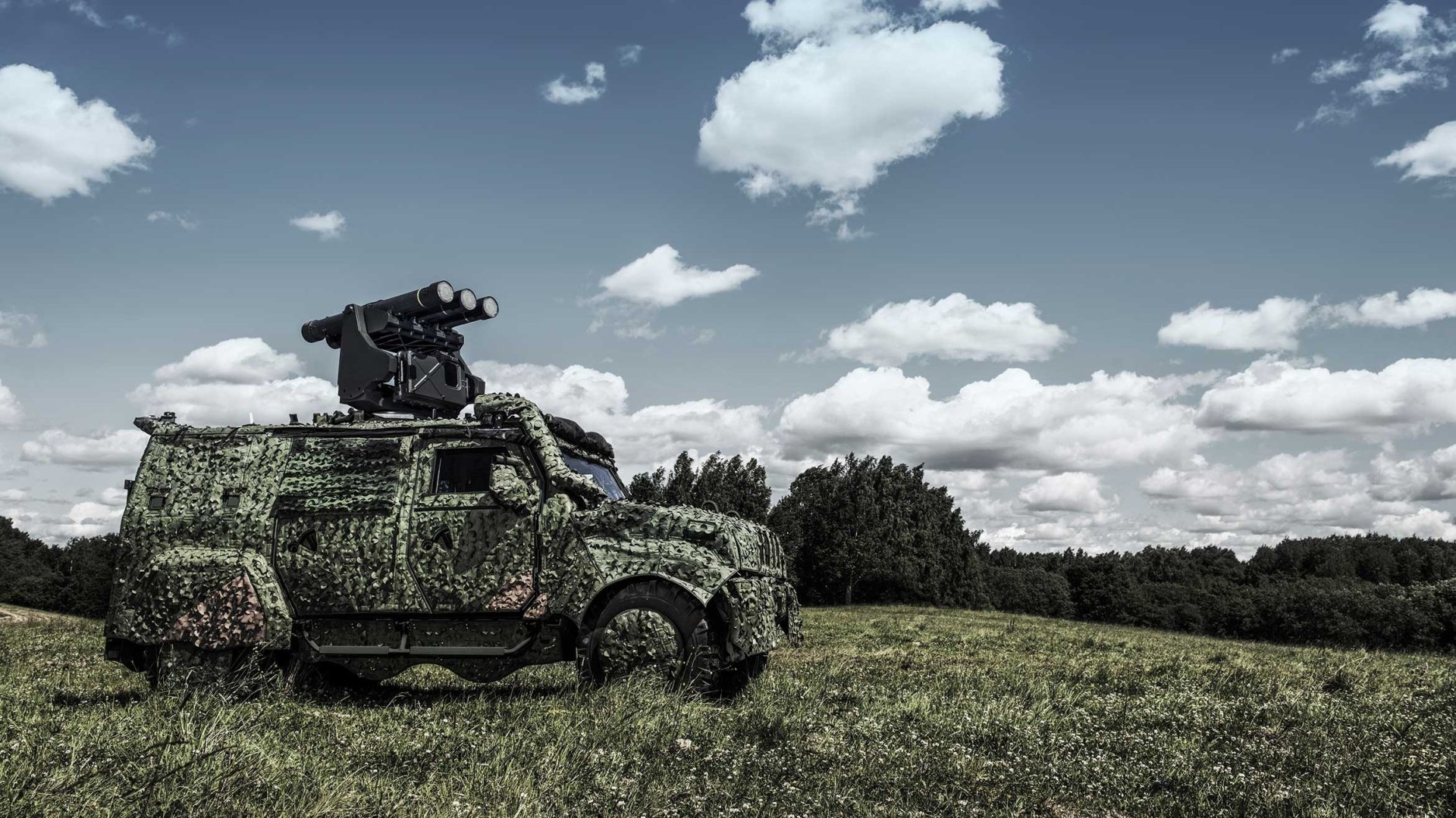 Saab Military Vehicle Camouflaged Against Cloudy Sky – HD Wallpaper