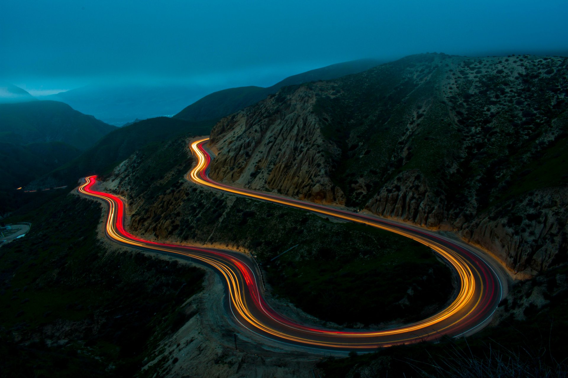 Nighttime Light Trails on Winding Mountain Road - HD Time Lapse Wallpaper